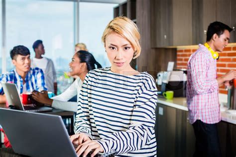 chinese programmer in lounge of it start up stock image colourbox