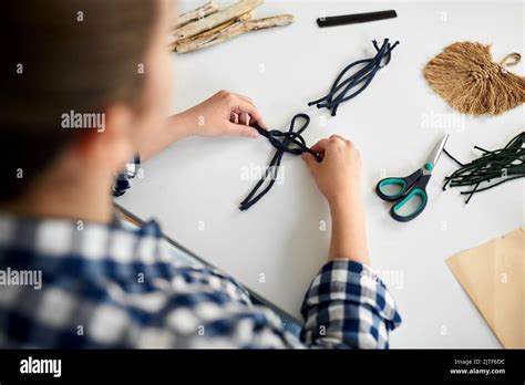 Woman Making Macrame And Knotting Cords Stock Photo Alamy