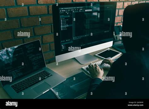 Hacker In The Hood Working With Computer With Hacking Breaking Into