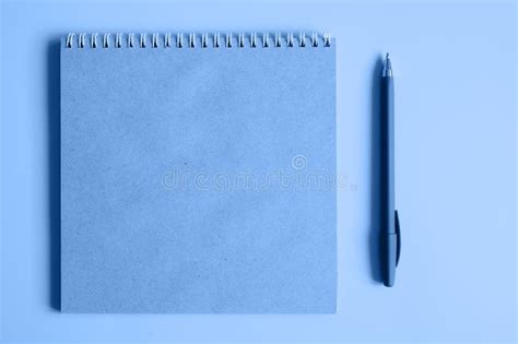 Notebook Or Sketchbook Made Of Craft Paper And A Pen On A Blue Background Space For Text Stock