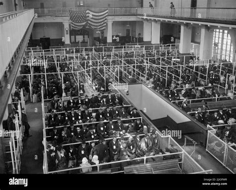 Immigrants Seated Waiting At Registry Room At Ellis Island Before Being