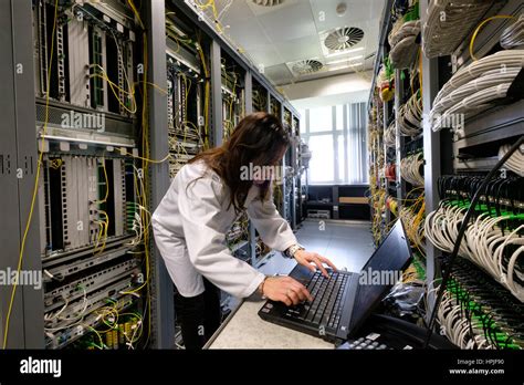 Female Engineer On Laptop Fixing Some Problems In A Server Room Stock Photo Alamy