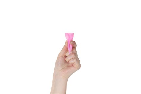 한 여성의 손이 그녀의 손가락에 그녀의 손에 들고 있는 분홍색 질 컵으로 여성의 생리 중에 퇴원을 수집합니다 흰색 배경 격리 클로즈업 경제에 대한 스톡 사진 및 기타 이미지