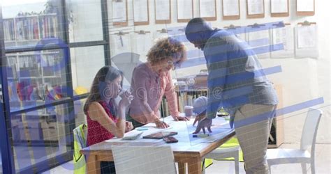 Animation Of Graphs And Loading Circles Over Diverse Coworkers Discussing Blueprint In Office