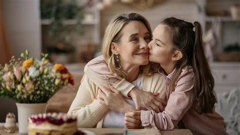 Premium Photo Daughter Kissing Mom On Mothers Day