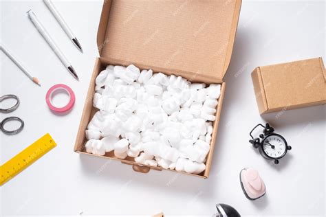 Premium Photo White Packaging Chips Styrofoam Peanut In Cardboard Box