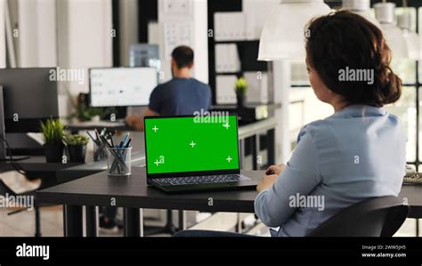 Employee Checks Greenscreen On Laptop Looking At Isolated Copyspace