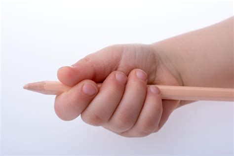 Premium Photo Hand Holding A Color Pencil