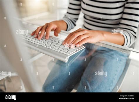 Businessperson Typing On A Keyboard Working On A Desktop Computer While