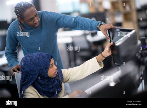 Black Muslim Female Software Developer Working Together With Her