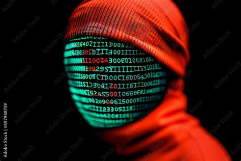 A Hooded Figure Shrouded In Darkness Their Face Obscured By A Digital