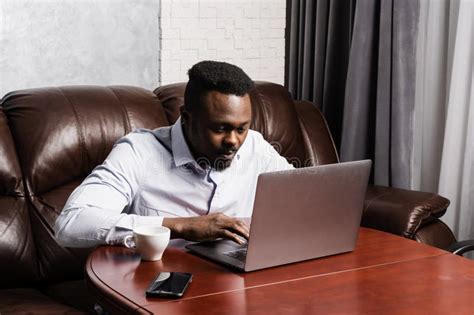 african american it developer with laptop is programming code in office