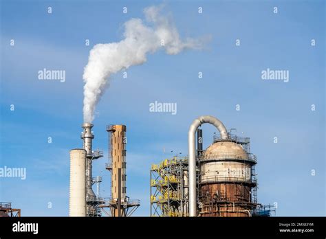 Steam Comes From A Tower In Oil Refinery With An Fccu Or Fluid Catalytic Cracking Unit At Right