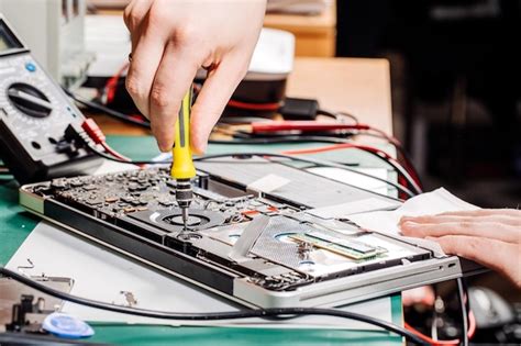 Premium Photo Woman Repairing Laptop Computer In Service Center Repairing And Fixing Service