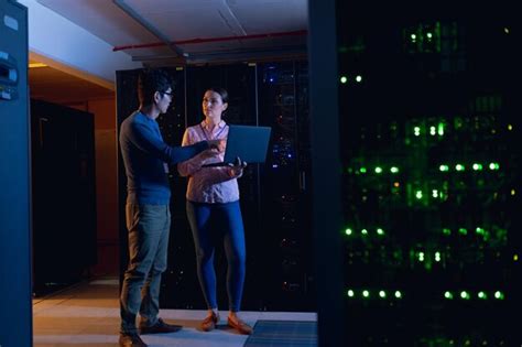 Premium Photo Diverse Male And Female Engineers Using Laptop In Computer Server Room Database