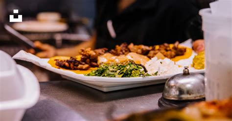 검은 재킷을 입은 여자가 음식과 함께 테이블 앞 의자에 앉아 있다 사진 Unsplash의 무료 음식 이미지