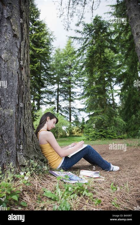 Girl Sitting Against Tree