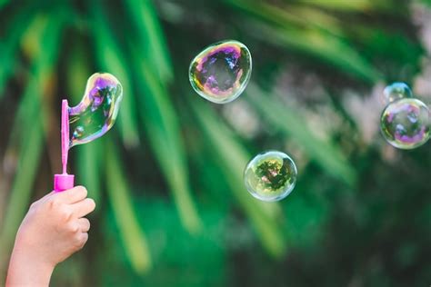 Premium Photo Close Up Of Hand Holding Bubbles
