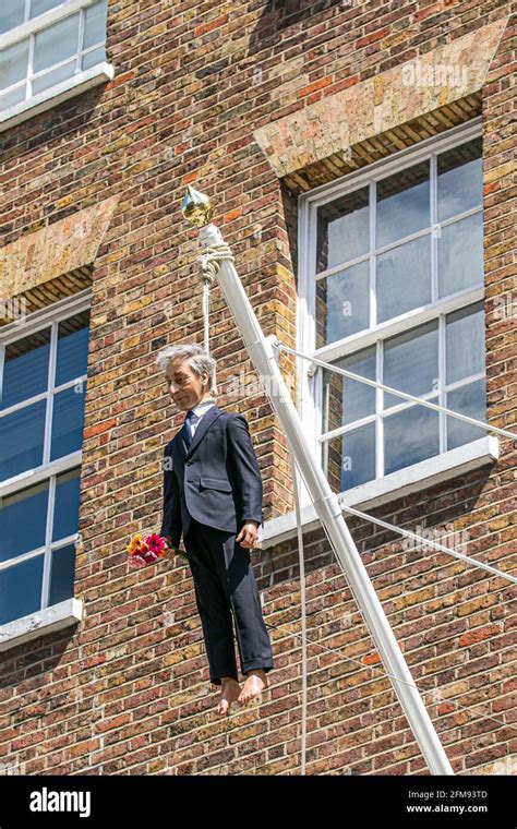 SAVILE ROW LONDON 7 May 2021 A Sculpture By Italian Artist Maurizio Cattelan Of A Man Holding A