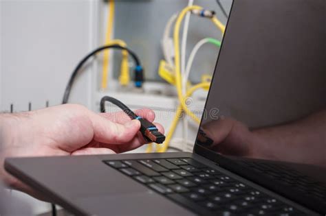 Technician Connecting Ethernet Cable To Laptop For High Speed Internet It Network Setup And