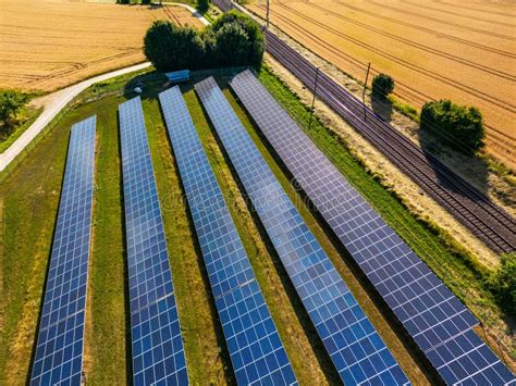 Solar Array Field With Solar Modules In The Countryside Next To A