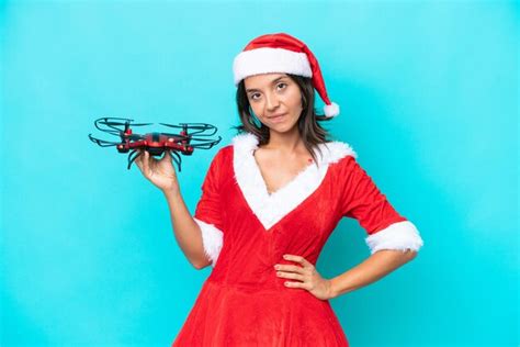 Premium Photo Young Woman Dressed As Mama Noel Holding A Drone