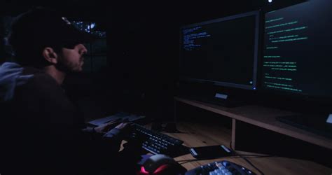 hacker sitting in dark room in front of stock footage sbv 309840238