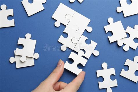 Woman Solving White Puzzle On Blue Background Top View Stock Image Image Of Creative Logical