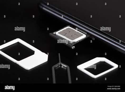 Sim Card Inserted Into The Sim Card Tray Of A Smartphone With Pin Needle Tray Remover Stock
