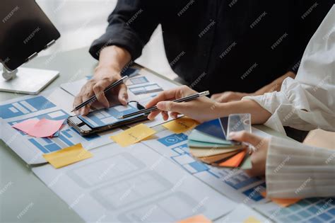 Premium Photo Ui Designer Brainstorming About Mobile App Interface Wireframe Design With