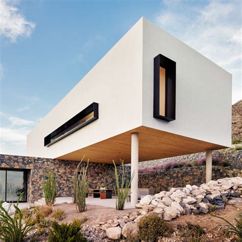 Volcanic Stone Contrasts With White Stucco At Texas Desert Home By Hazelbaker Rush