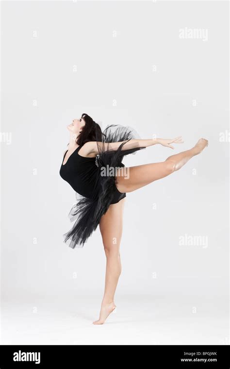 Beautiful Female Ballerina Doing Split Against White Background Stock