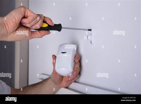 Electrician Installing Security System Door Sensor On Wall Stock Photo Alamy