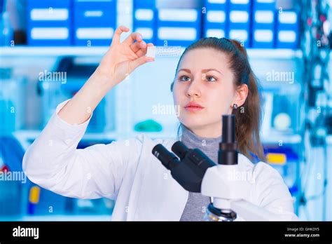 Woman Technician With Microscope Slide In Lab Stock Photo Alamy
