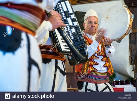 A Group Dressed In Traditional Costumes Perform Albanian Music And