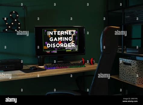 Internet Gaming Disorder Modern Computer And Rgb Keyboard On Wooden Table In Dark Room Stock