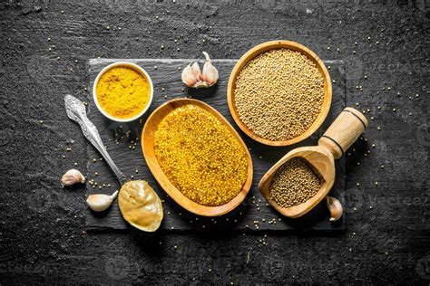 Different Types Of Mustard On A Stone Board With Garlic Stock Photo At Vecteezy