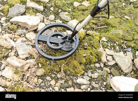 A Man With A Metal Detector On The Shore Of A Reservoir Metal Searches In The Coastal Zone