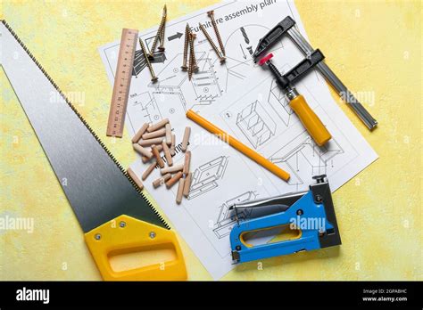 Furniture Assembling Instructions Plan And Different Tools On Yellow