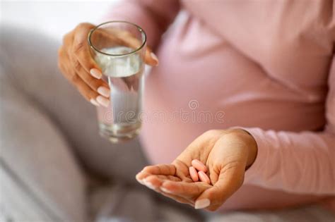 Prenatal Vitamins And Supplements Unrecognizable Black Pregnant Woman Taking Pills At Home