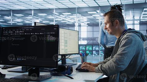 It Technician Looking At Pc Screen Working In Network Security Data Center Ensuring Optimal