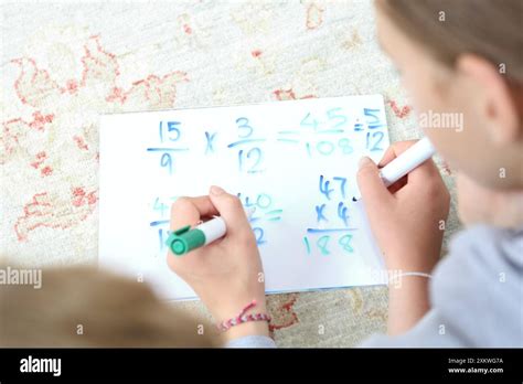 Girls Doing Maths Math Lying On Floor Writing On Whiteboard With Pens Fractions Multiplying Girls Doing Maths Math Lying On Floor Writing On Whiteboard With Pens Fractions Multiplying
