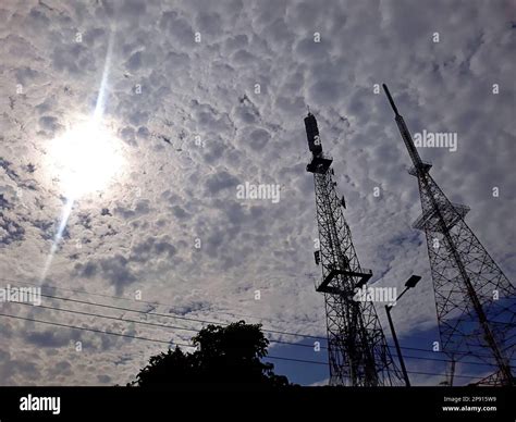 television frequency transmitting and receiving tower against a backdrop of sparse clouds and