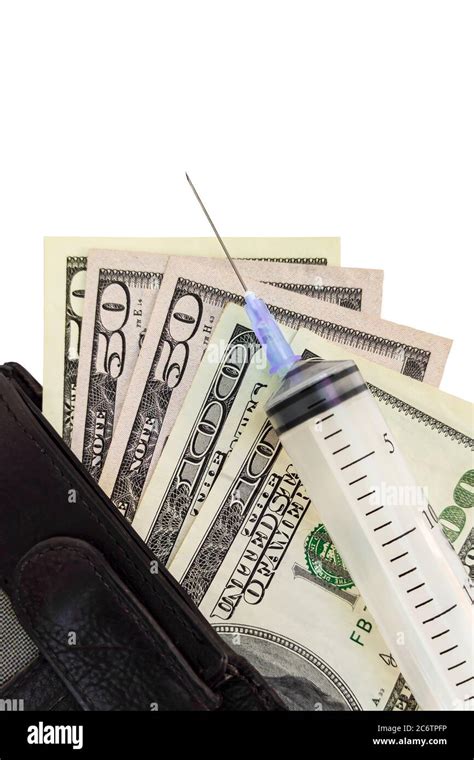 Money Peeks Out Of A Purse And A Syringe With An Open Needle Lies On
