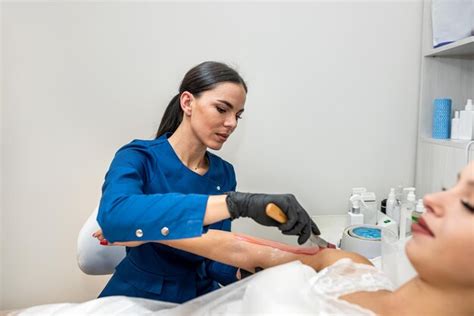 Premium Photo Beautician Doing Epilation Procedure For Unwanted Hair