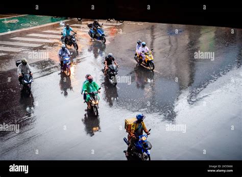 Cars Vans Buses And Motorbikes All Pass Along A Busy Intersection On
