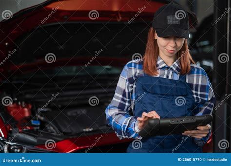 Caucasian Female Auto Mechanic Uses A Special Computer To Diagnose Faults Stock Photo Image