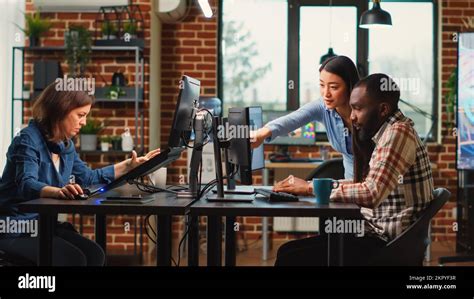 Young Team Of Professional Developers Using Skills To Create Engineering Infographics Using Cad