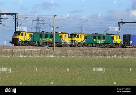 Two Class 90 Electric Locomotives Hauling A Container Freight Train
