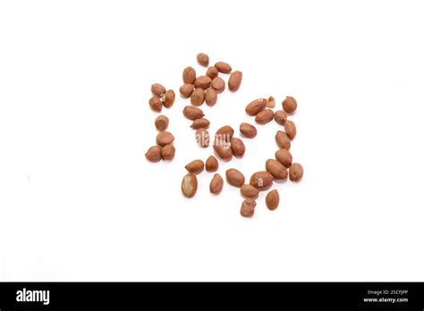Peanuts In Various Orientations Are Scattered On A Clean White